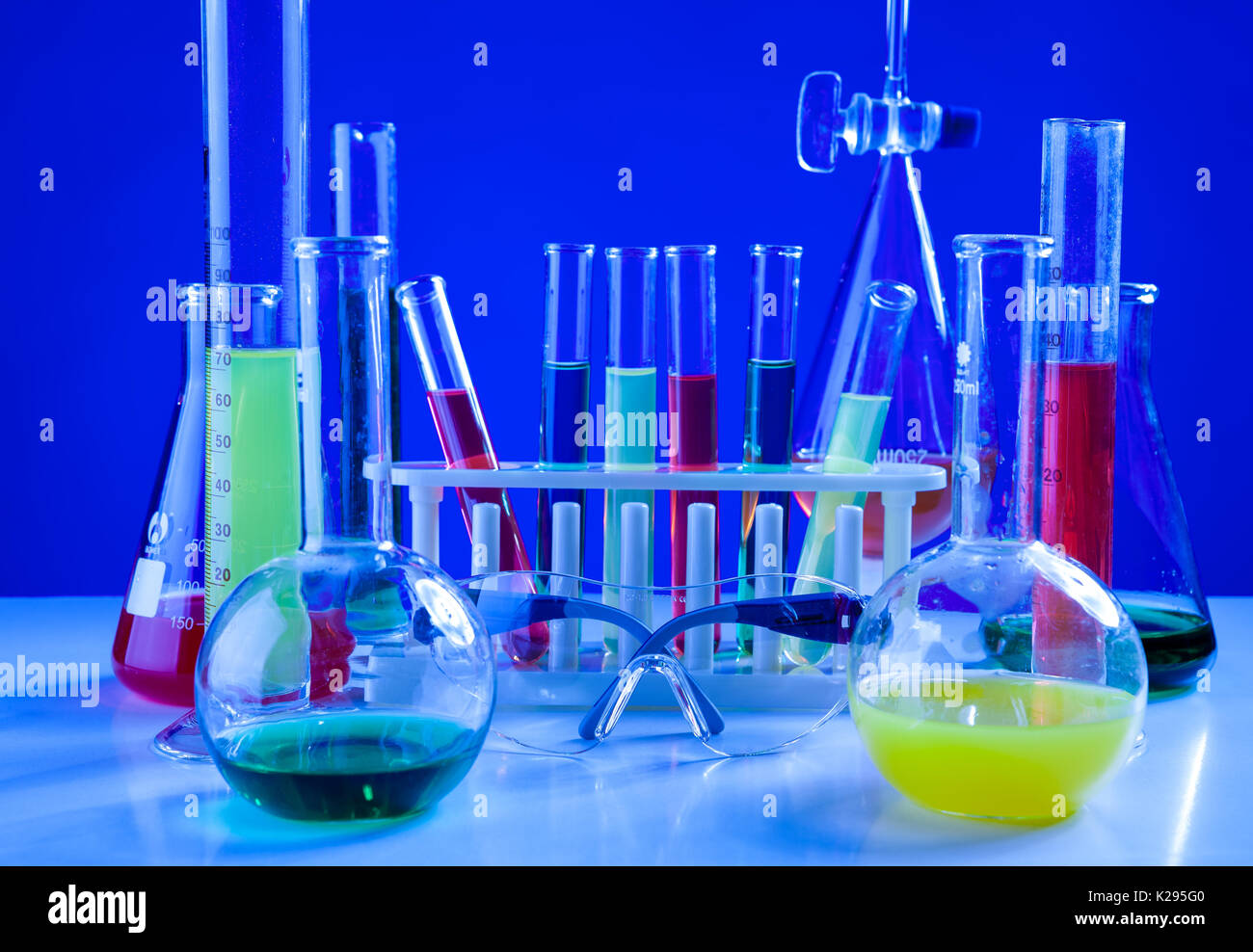 Different Chemistry lab set on a table over blue background Stock Photo ...