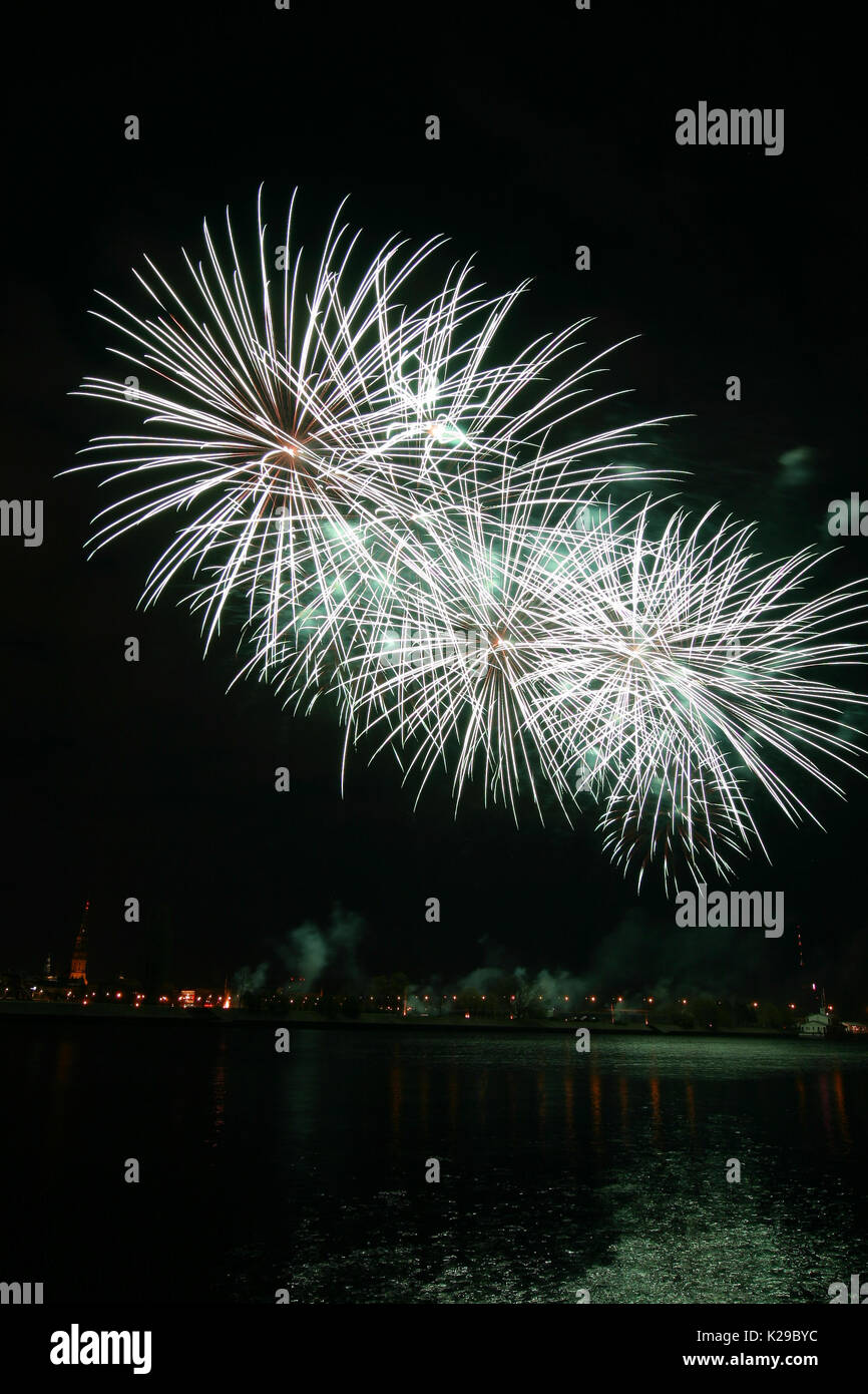 Beautiful, colorful fireworks above the river during an Independence ...