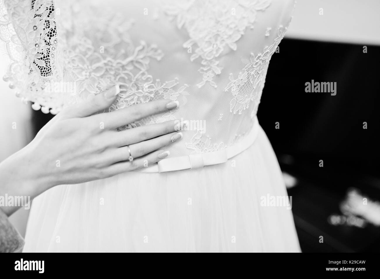Close-up photo of bride's hand on a dress. Black and white photo Stock ...
