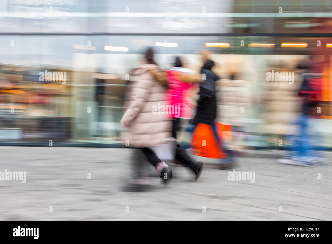 A shopper walking in front of shop window Stock Photo - Alamy