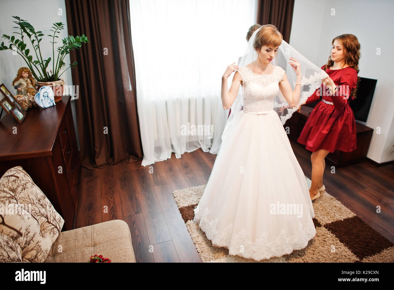 Beautiful bridesmiads help bride to get ready for her wedding ceremony ...