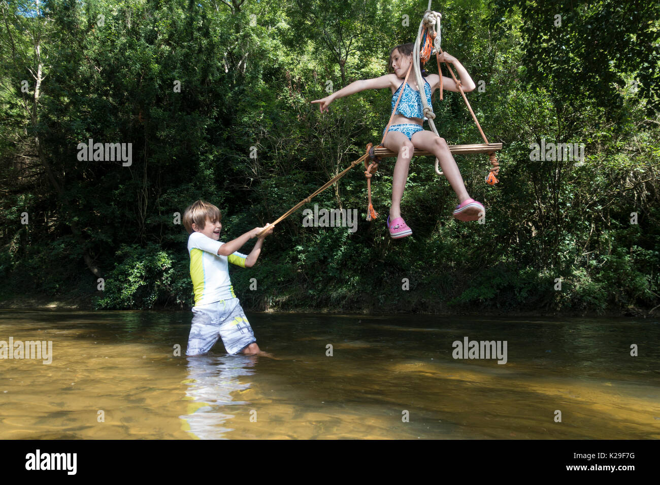 Children Playing on River Swing Stock Photo - Alamy