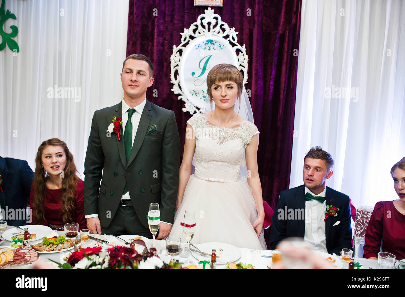 Awesome wedding couple standing at their table with bridesmaids and ...
