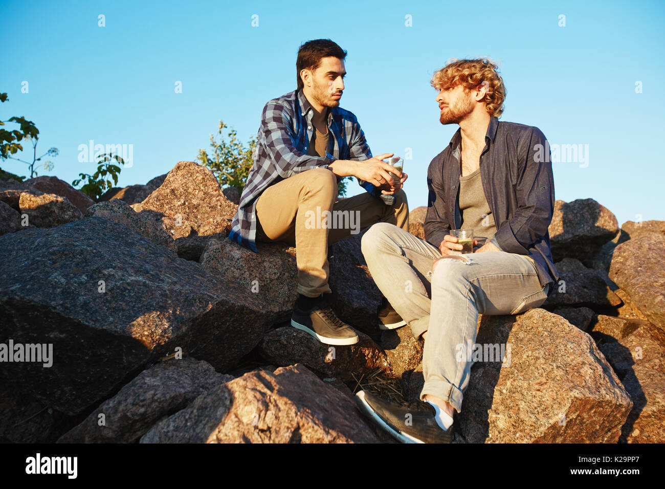Male Friends Chatting with Each Other Stock Photo - Alamy