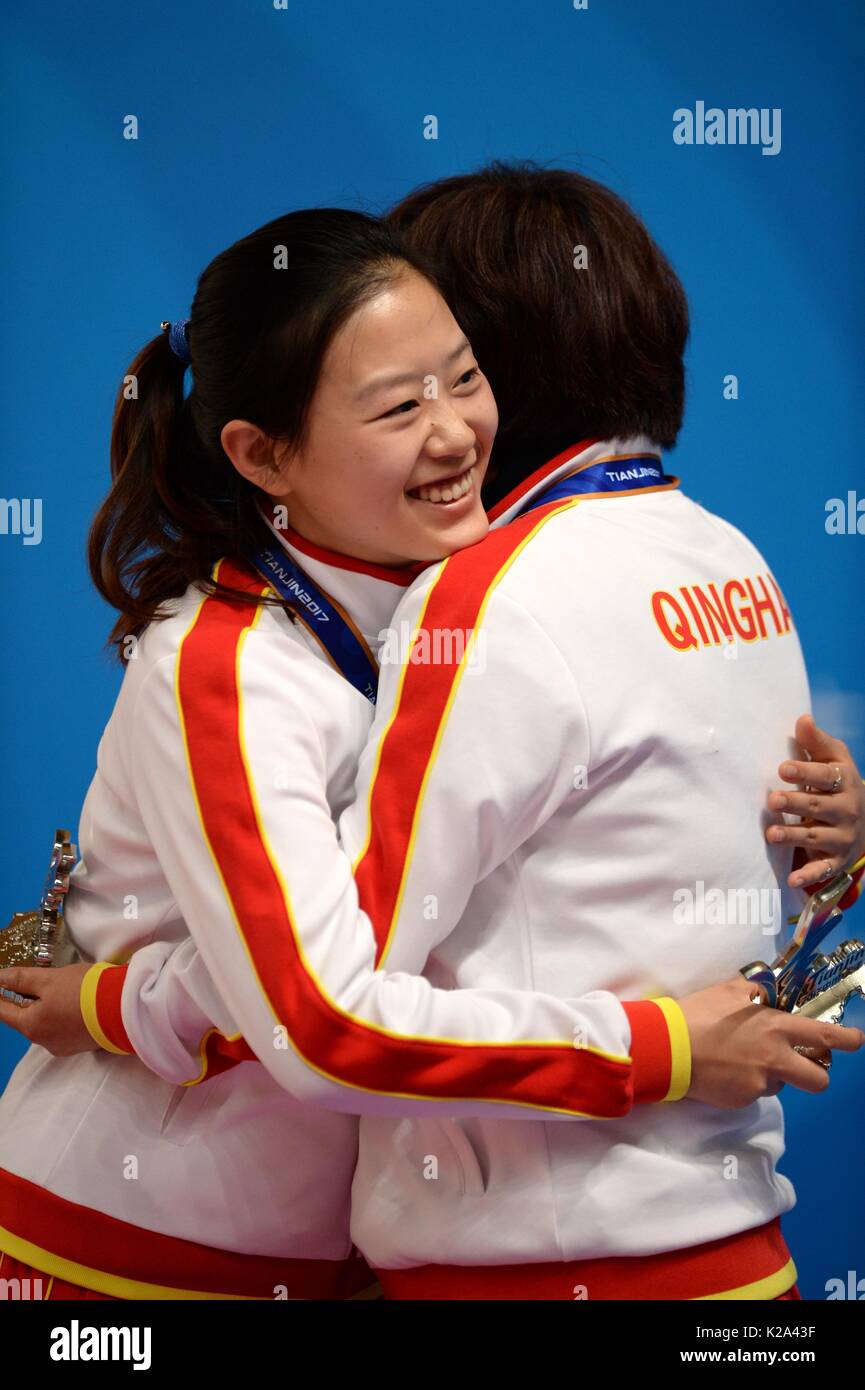 Tianjin. 30th Aug, 2017. Ji Xiaojing (L) of Qinghai hugs her coach during the awarding ceremony ...