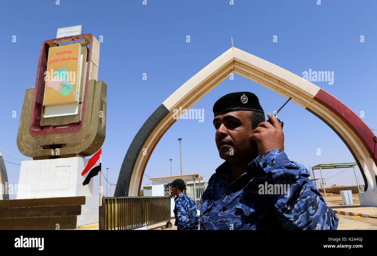 Amman. 30th Aug, 2017. An Iraqi policeman gestures on the Iraqi side of ...