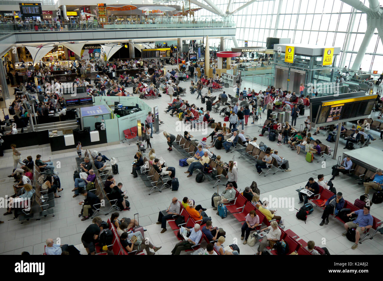 Passengers in Heathrow Airport, London, England Stock Photo - Alamy
