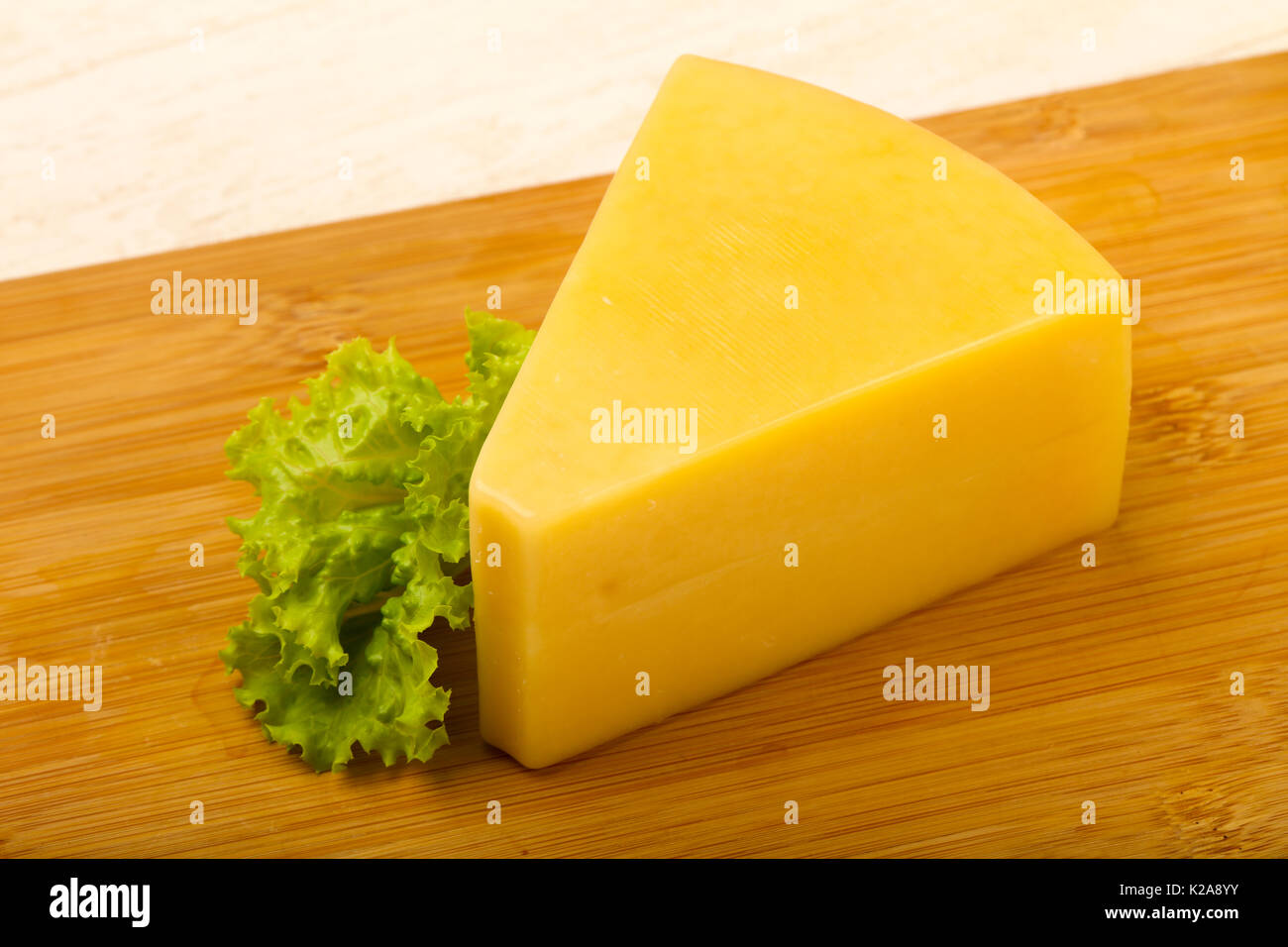 Parmesan cheese triangle Stock Photo - Alamy