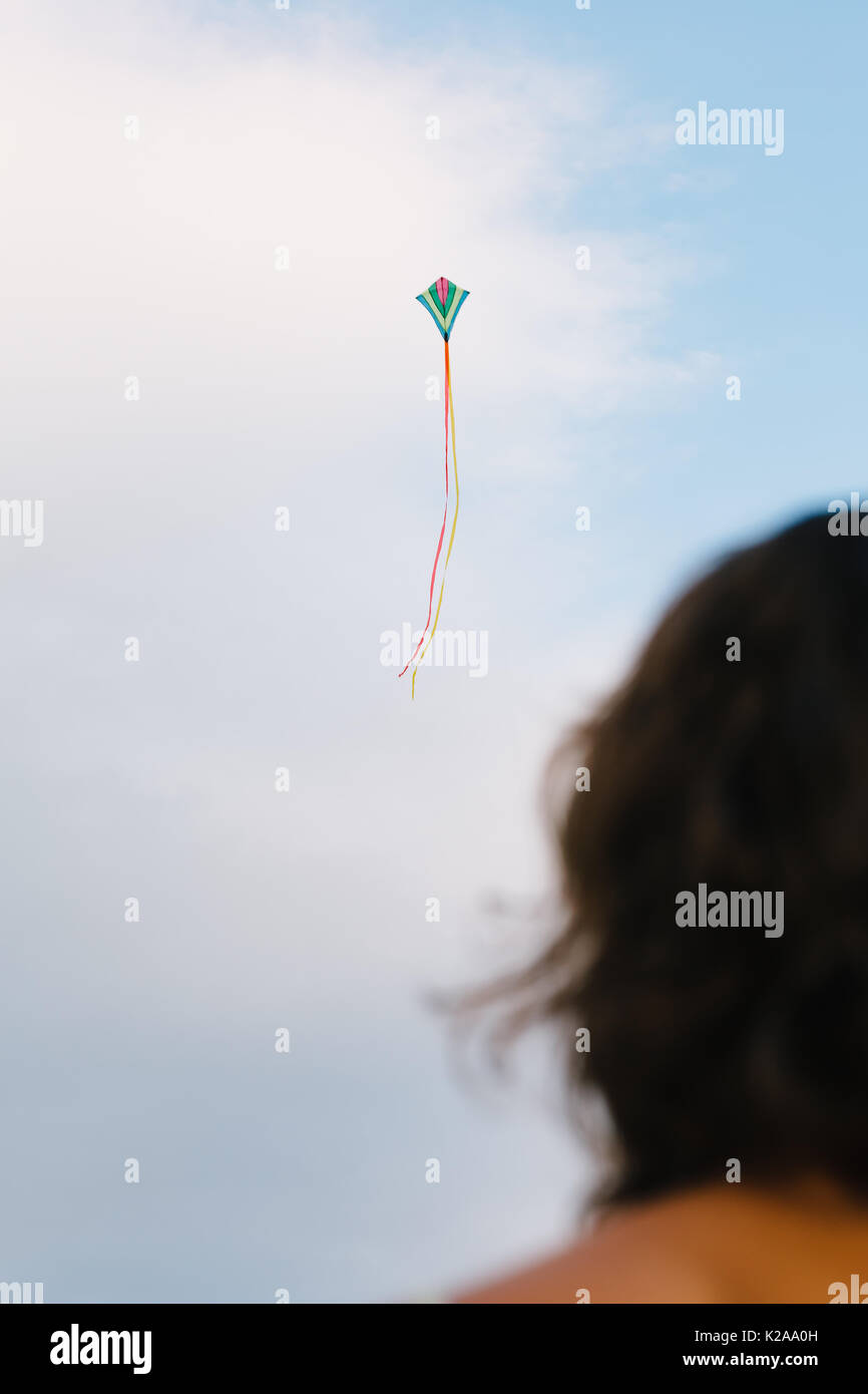 Girl watching kite flight Stock Photo - Alamy