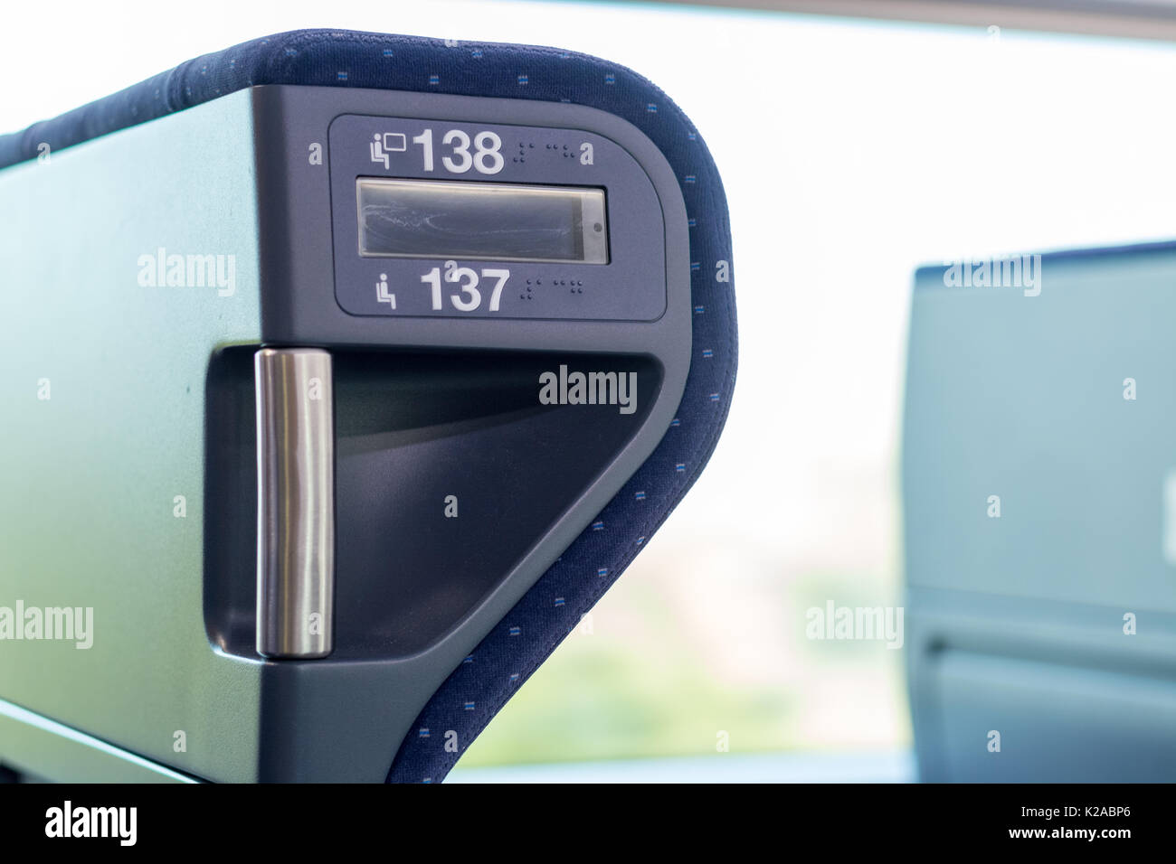 Blue train seats numbers whit bright window close up Stock Photo - Alamy