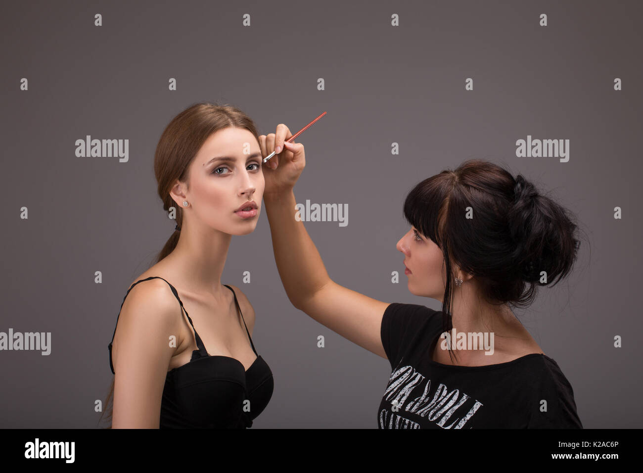 Makeup artist doing makeup for models for a photo shoot Stock Photo - Alamy