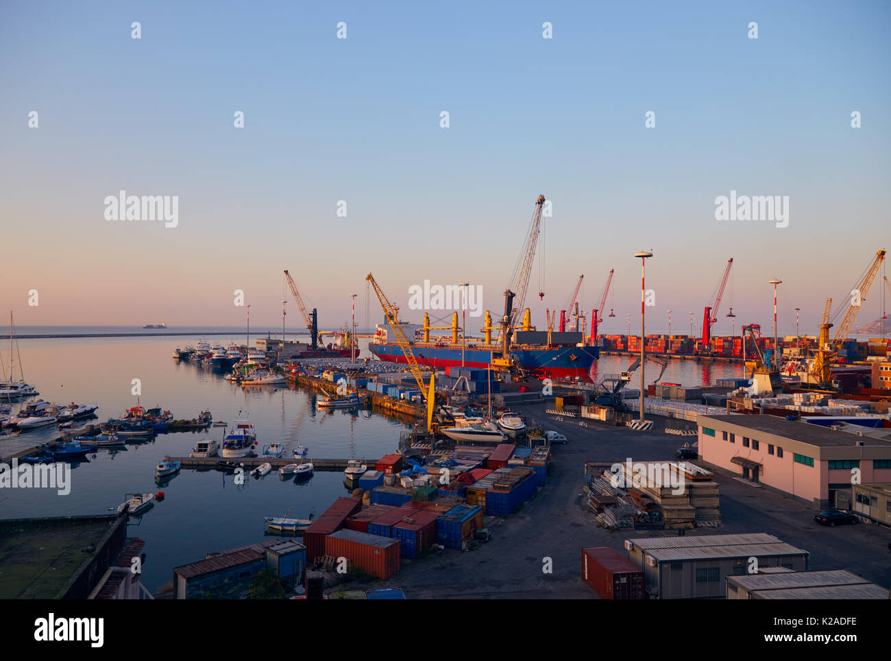 Port terminal with cranes, ships and containers near Salerno at dawn ...