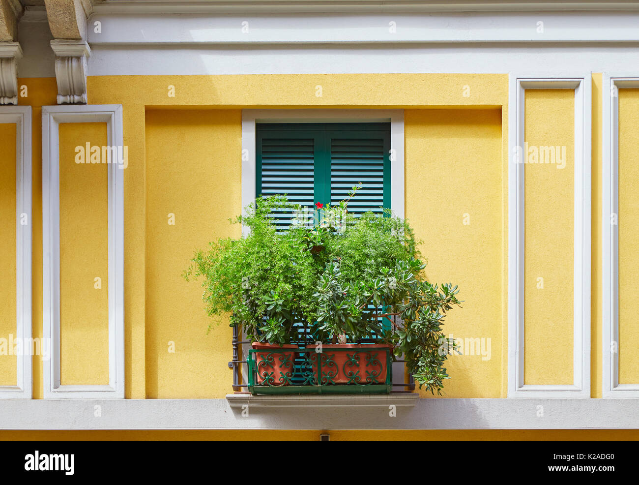 The window of one of the houses in the center of Milan is shuttered and ...