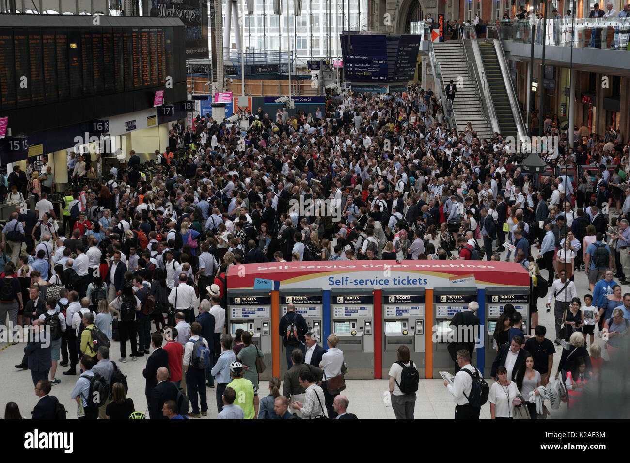 Commuters at Waterloo Station, London, during the evening rush hour, as ...