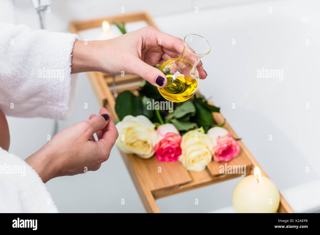 Woman preparing wellness bath in tub Stock Photo - Alamy