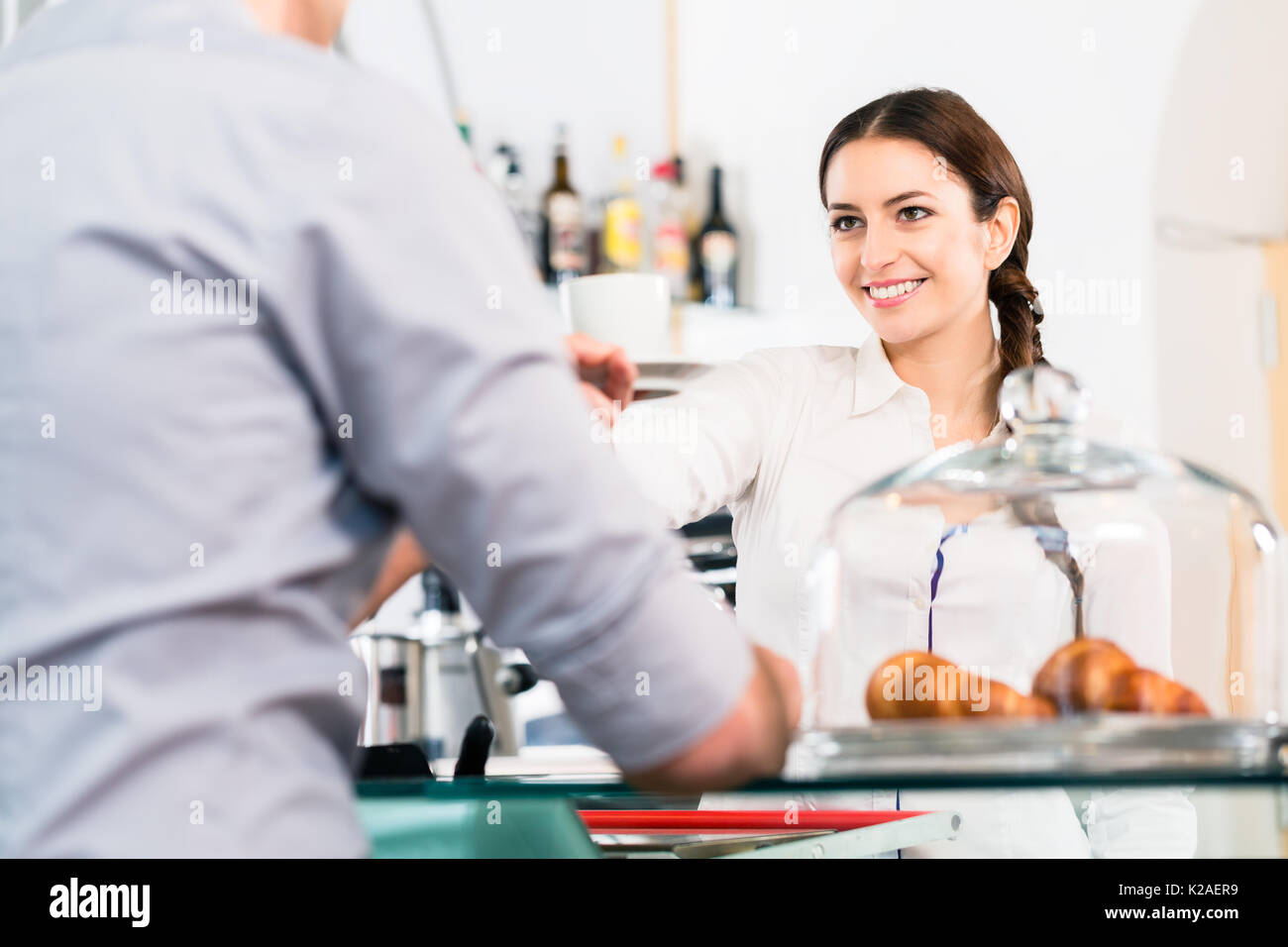 Beautiful waitress serving male customer with a cup of coffee fo Stock ...