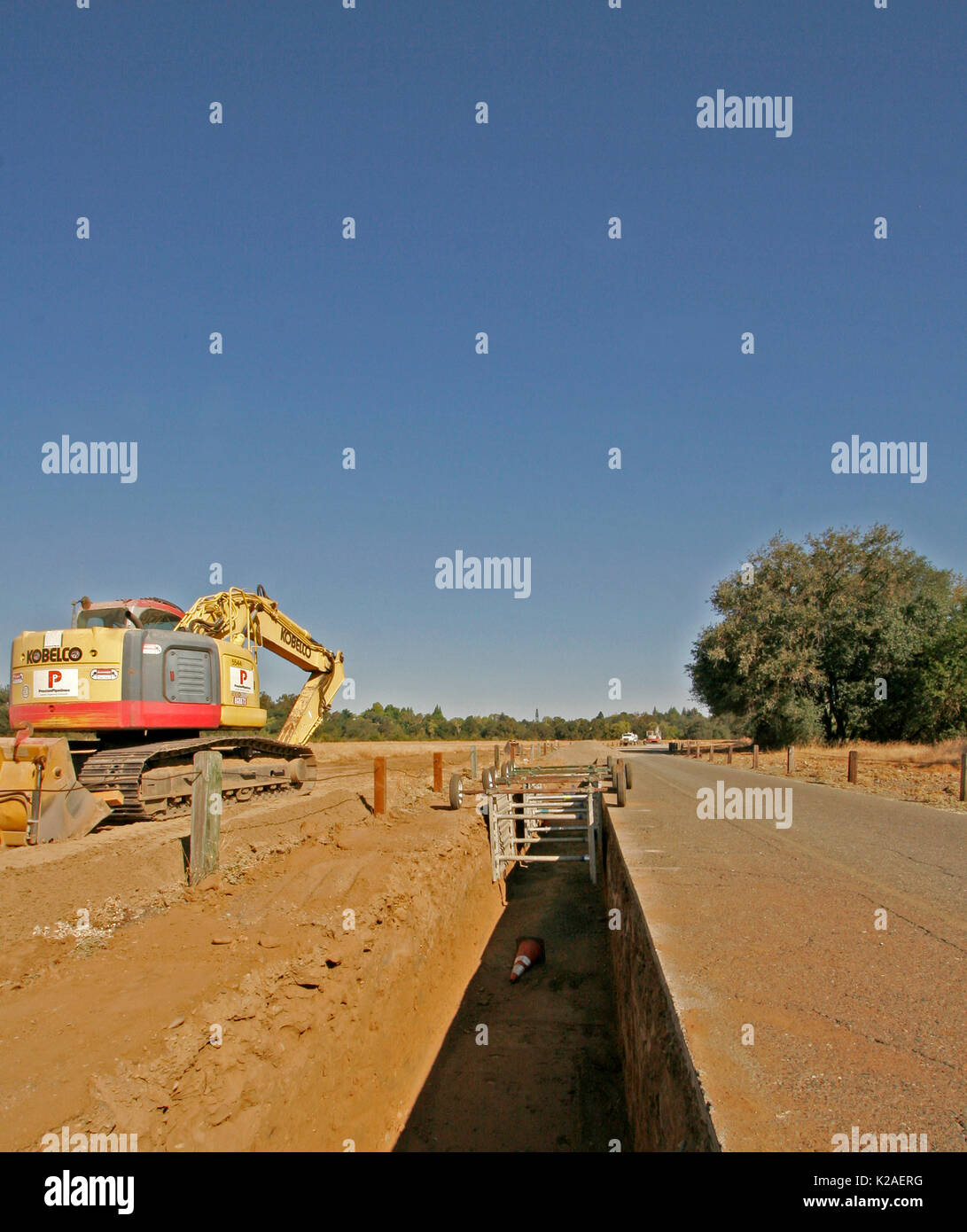 TRACKED EXCAVATOR AT DIG SITE AND VIEW ALONG DITCH WITH SAFETY SHORING ...