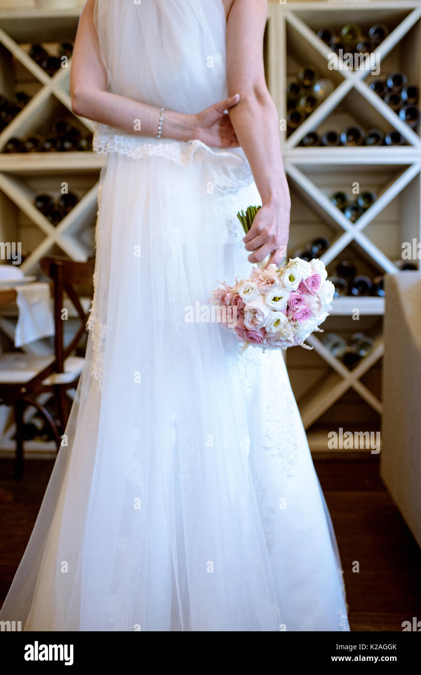 Beautiful bride is holding a wedding colorful bouquet Stock Photo - Alamy