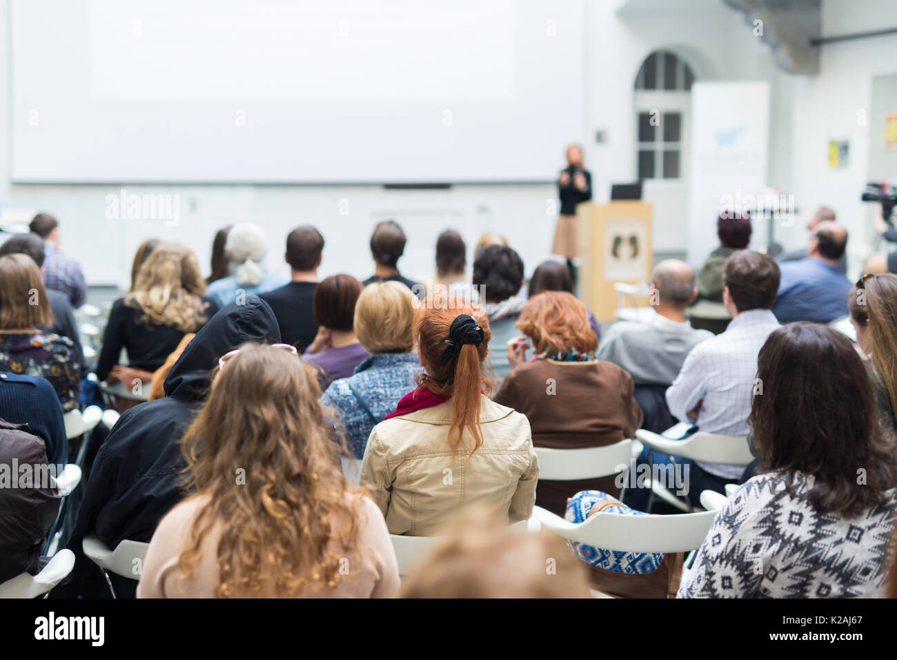 Woman giving presentation in lecture hall at university Stock Photo - Alamy