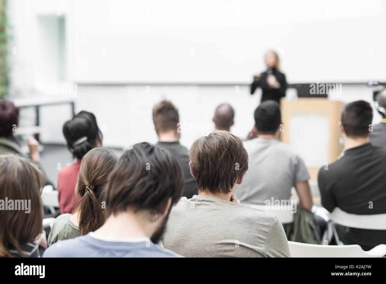 Woman giving presentation on business conference Stock Photo - Alamy
