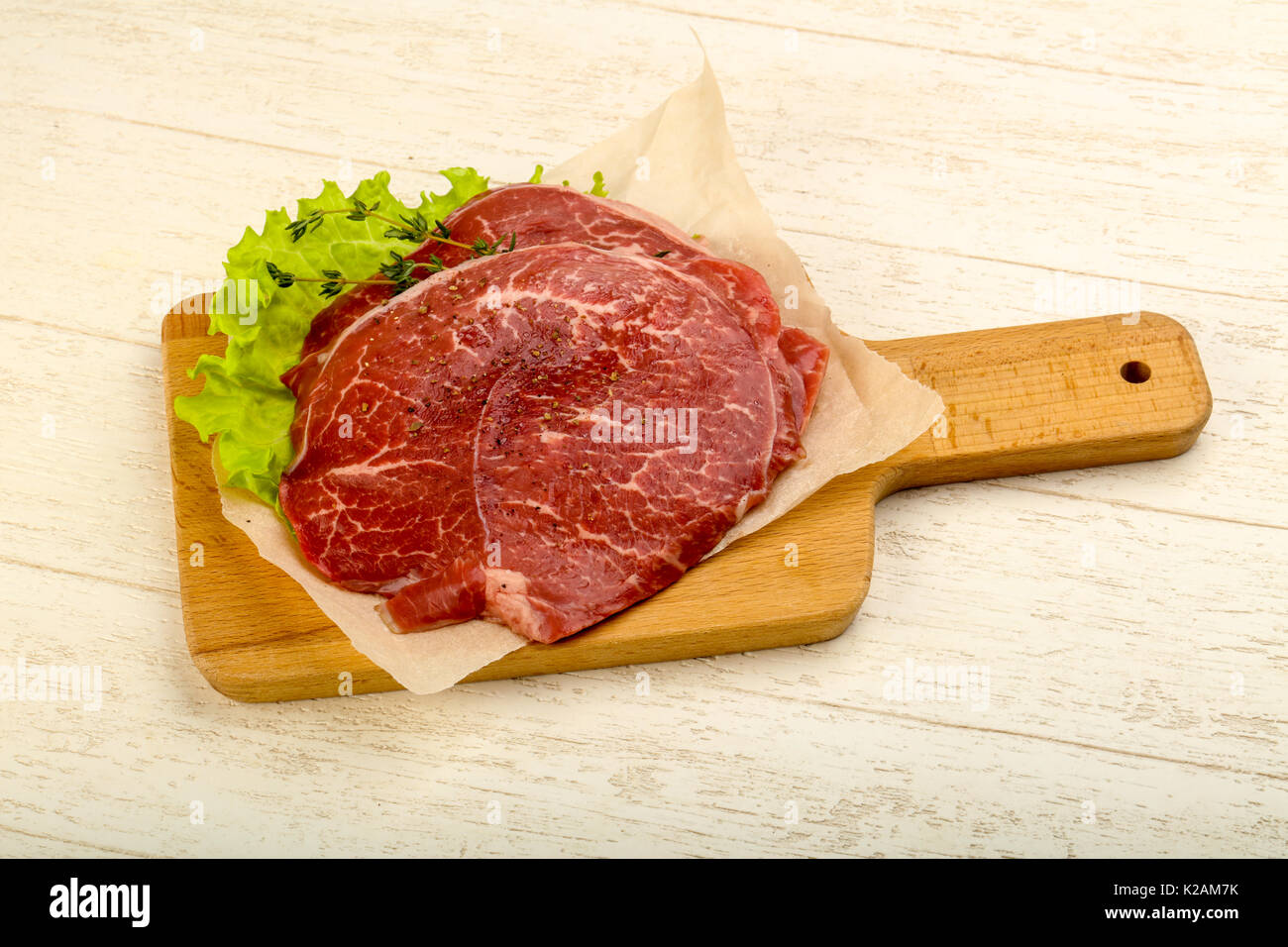 Raw beef schnitzel with spices ready for griil Stock Photo - Alamy