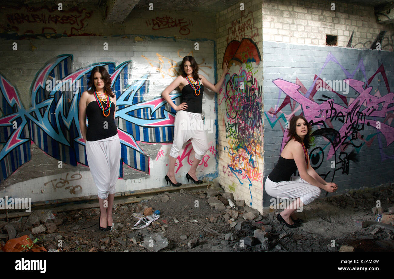 Three girls - triple exposure - against a graffiti covered wall Stock ...