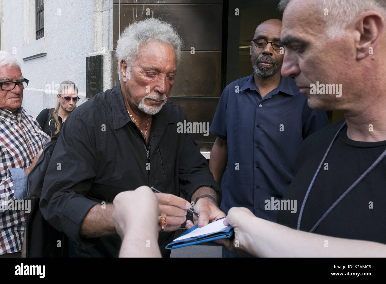 Sir Tom Jones signing autographs on his arrival at the Teatro Real in ...