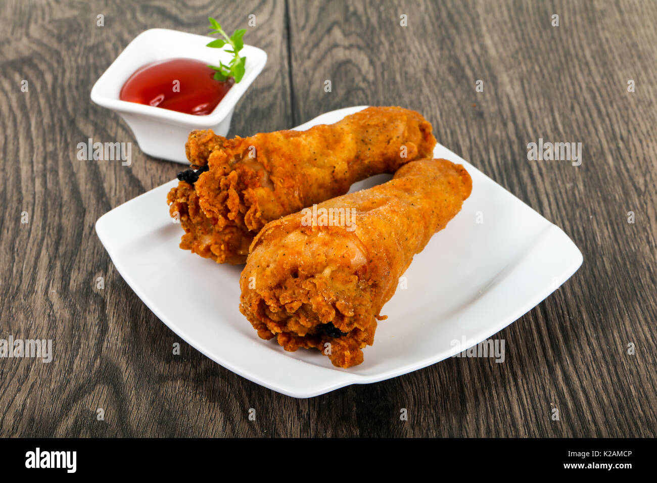 Crispy chicken legs with ketchup Stock Photo - Alamy