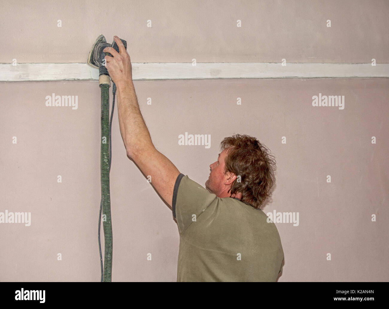 Painter sanding wooden beam Stock Photo - Alamy