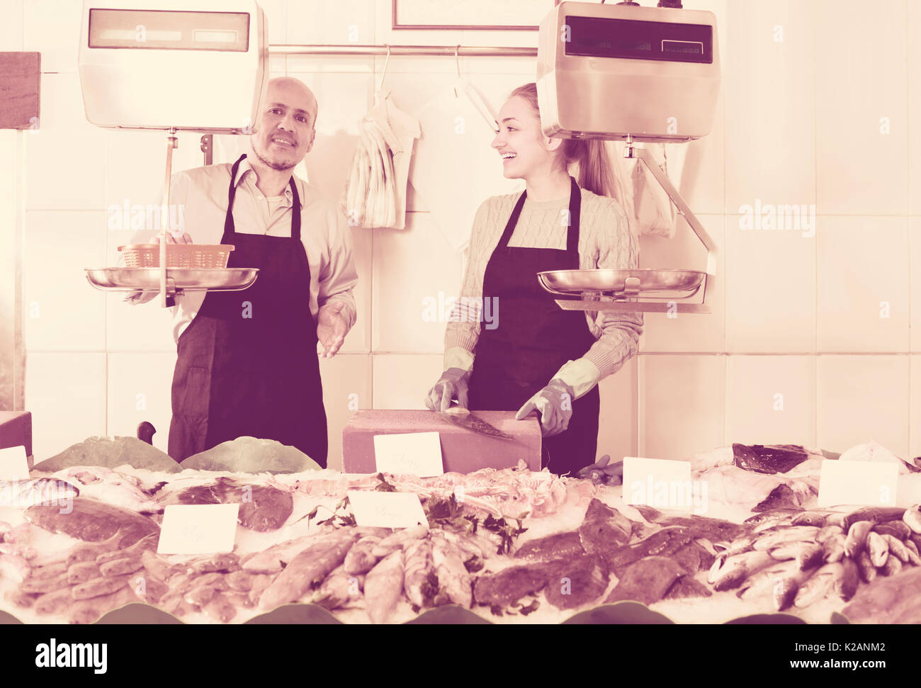 Ordinary fish and seafood store with two cheerful friendly sellers ...