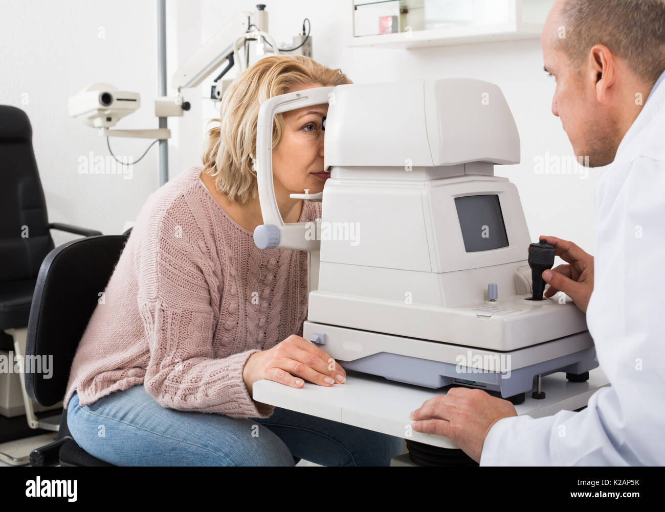 Female ophthalmologist checking male hi-res stock photography and ...