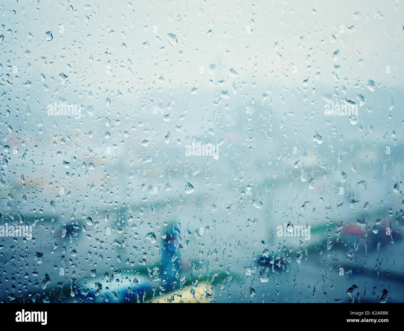 Rain in city, water drops on wet window glass. Blured background Stock Photo - Alamy