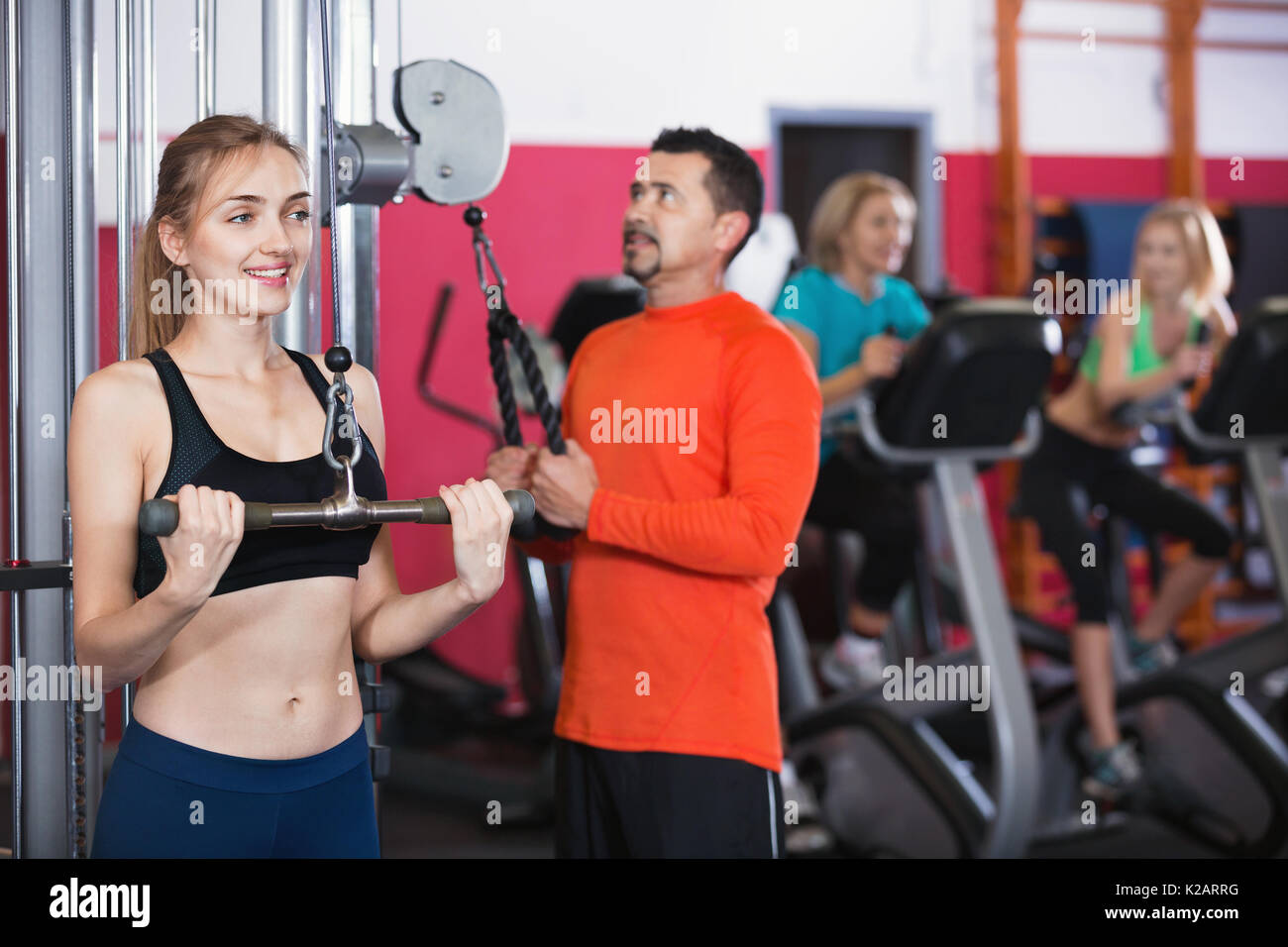 Active smiling people weightlifting training in modern health club ...