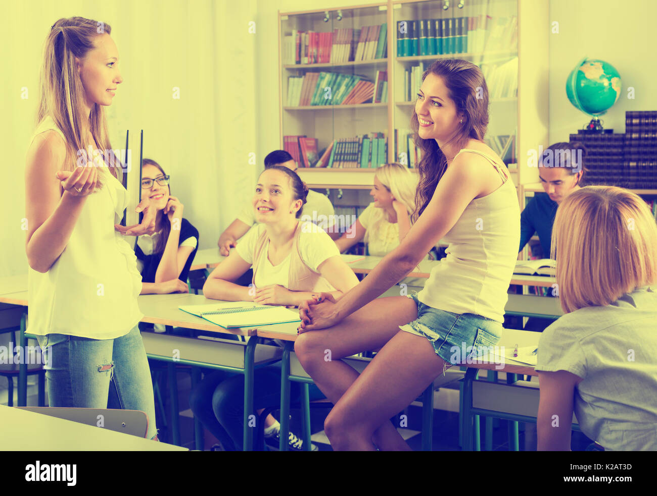 Smiling young students during break in classroom interior Stock Photo ...