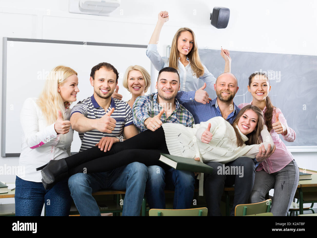 Smiling adult students and coach posing at training session school ...