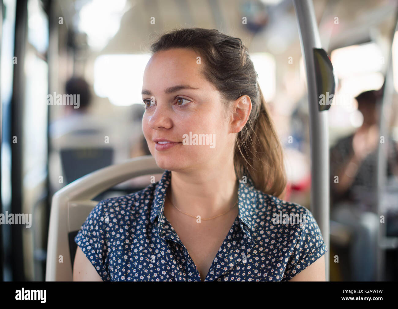 Portrait of cheerful woman passenger sitting in public bus Stock Photo ...