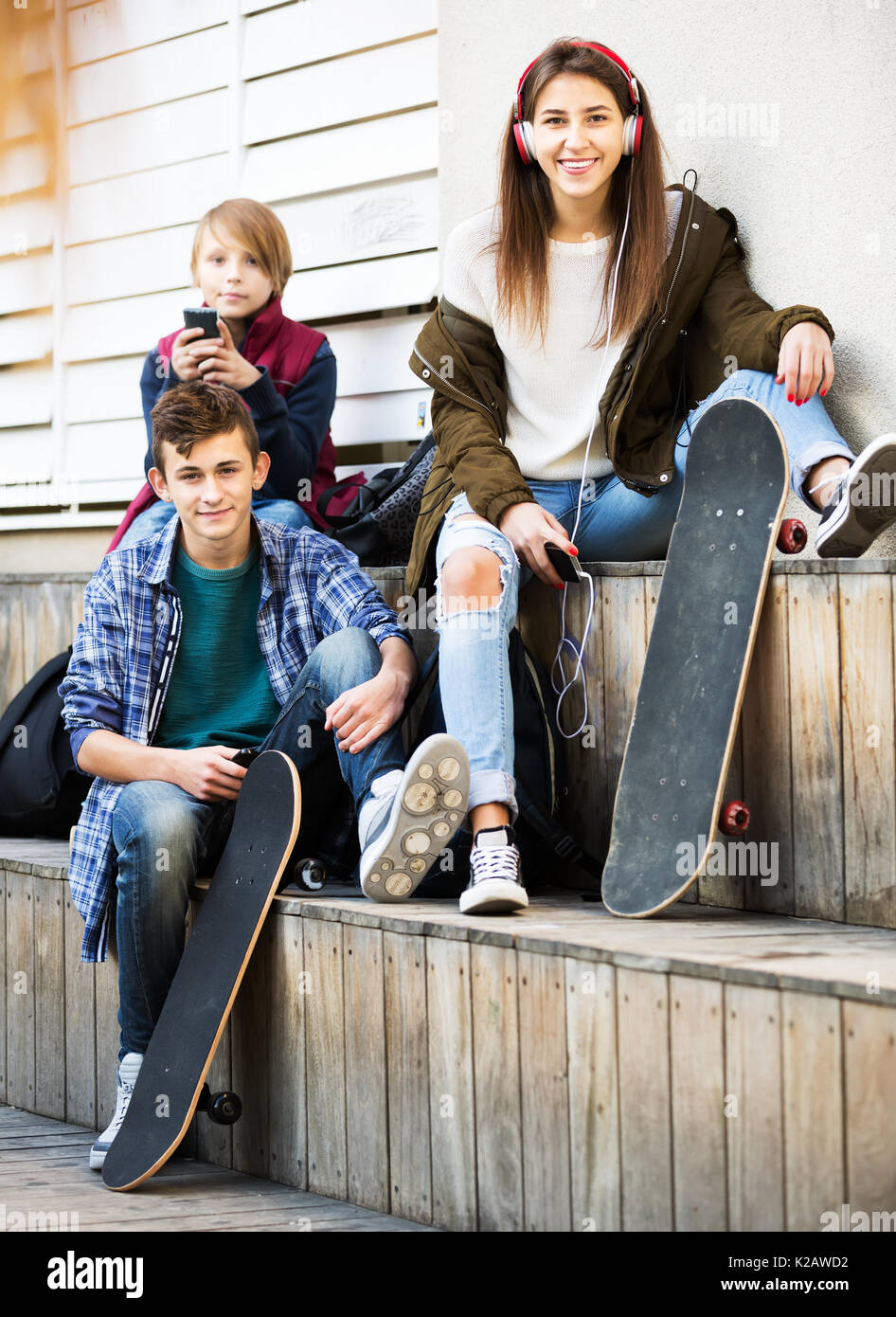 Group of teenagers relaxing with mobile phones outdoor Stock Photo - Alamy