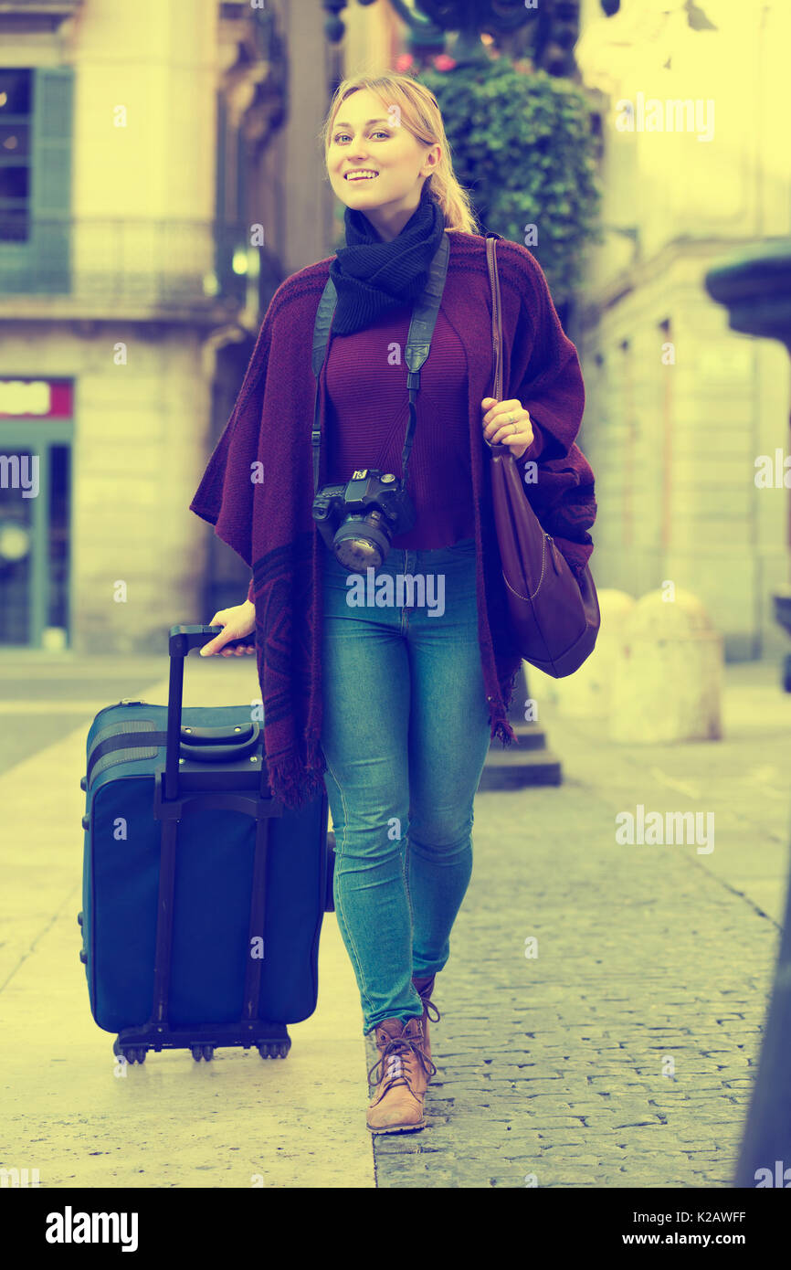 Cheerful and inquisitive young woman taking a journey in the city Stock Photo - Alamy