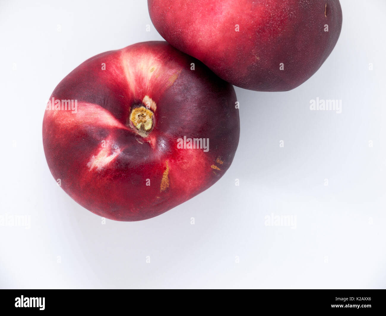 Two Nectarines sit on a white background Stock Photo - Alamy
