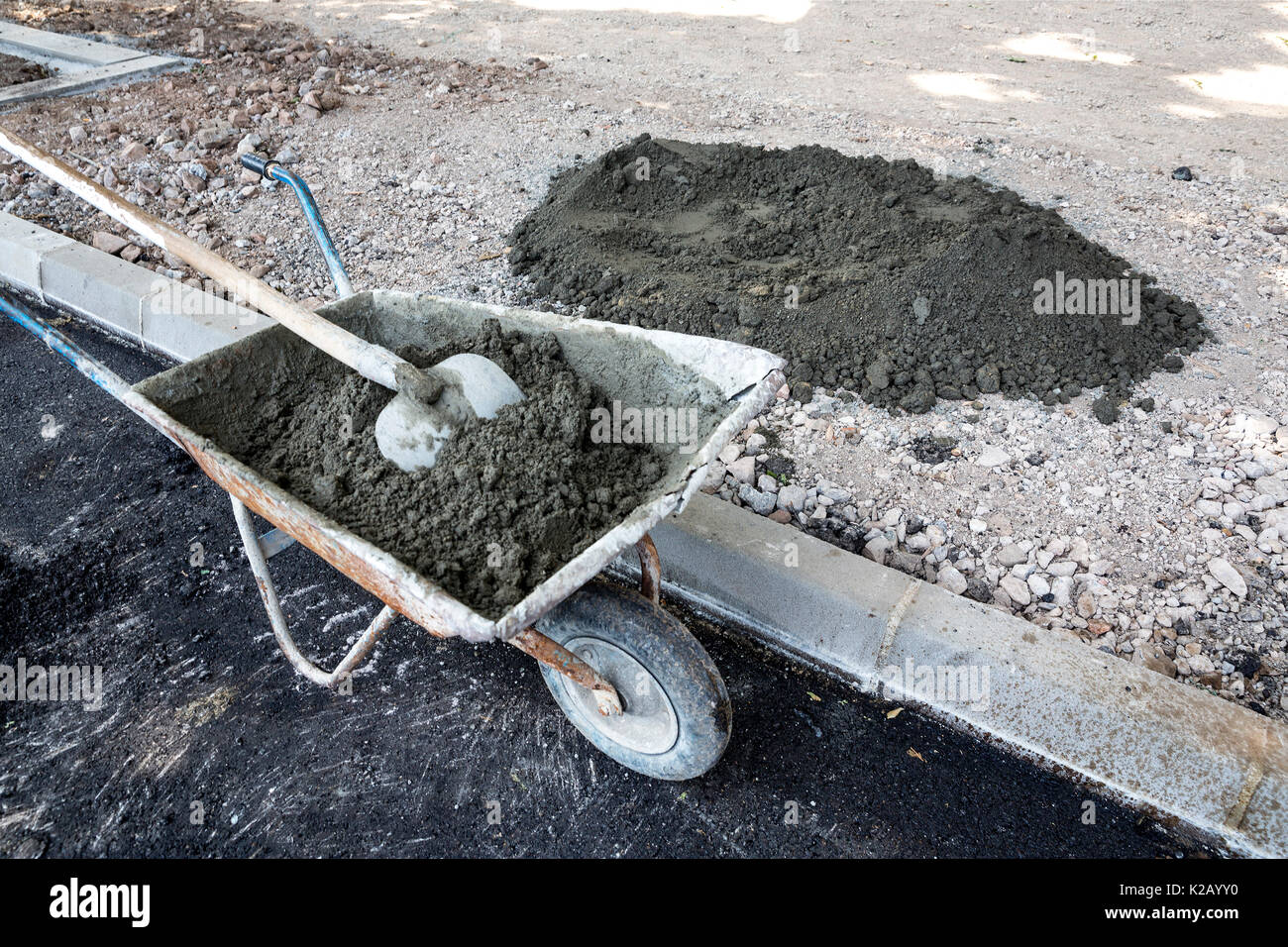 Construction cart full with asphalt and a shovel on a construction site ...