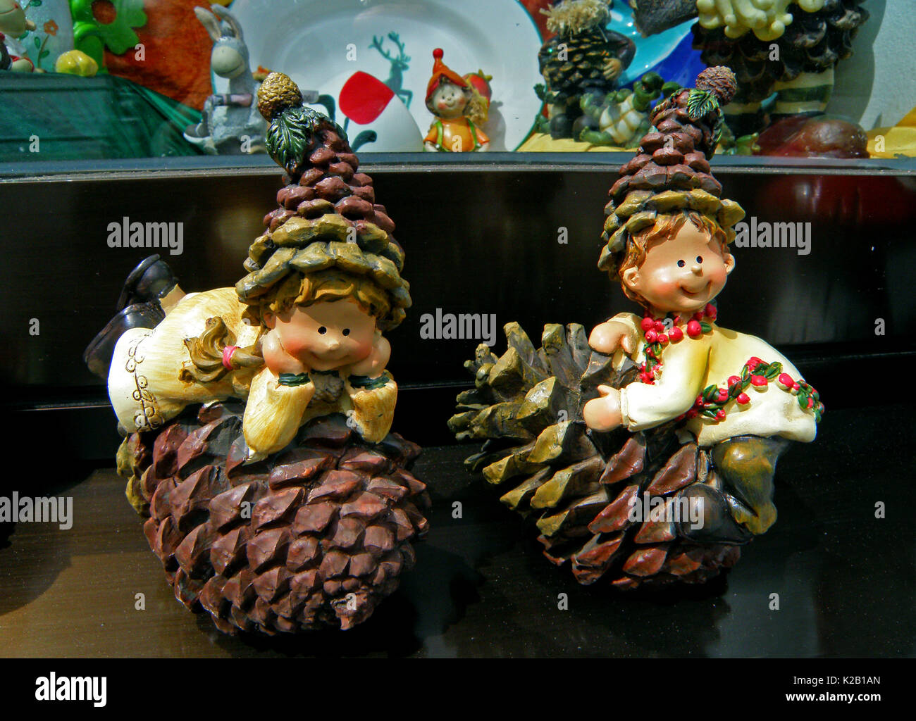 Little Boy and Girl Figurines with Pine Cone Hat Playing on the Brown ...