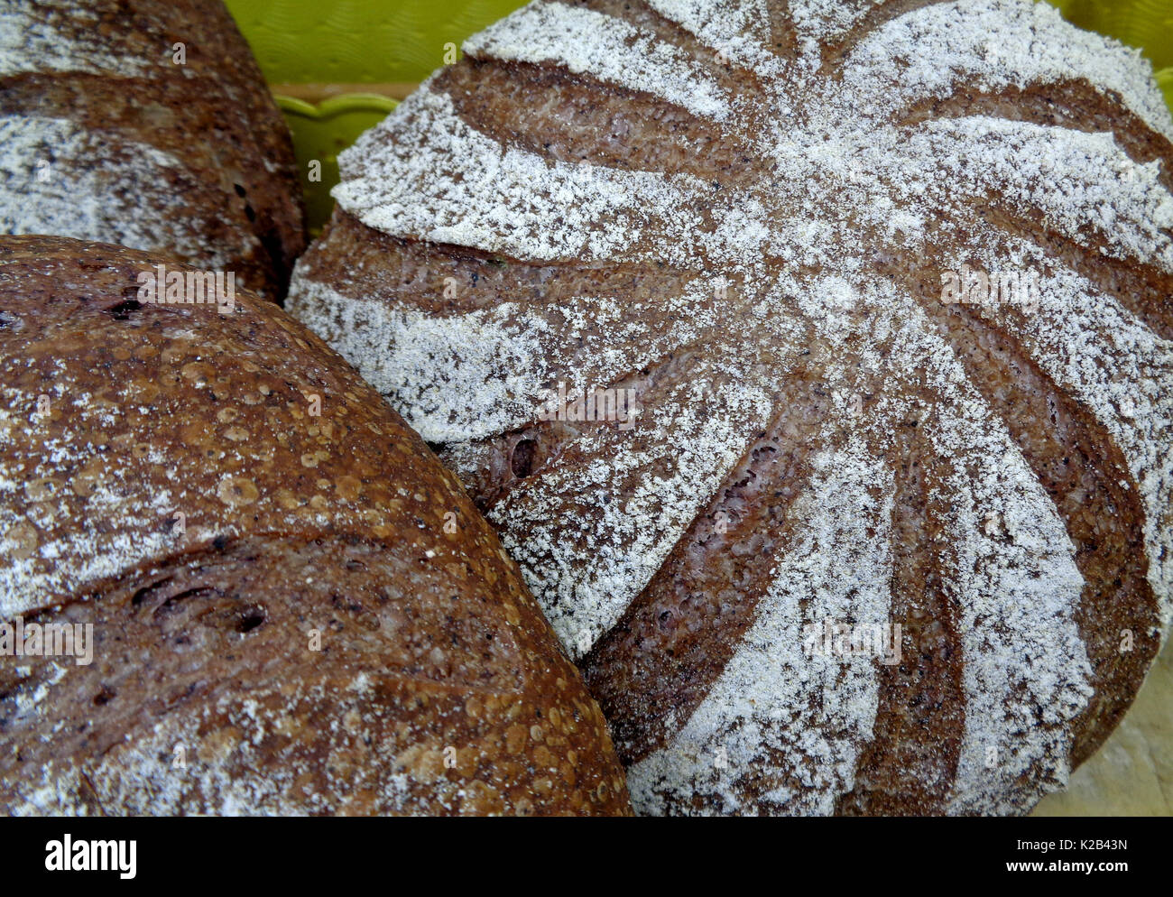 Dark brown whole grain bread loaves, closed up for background, texture ...