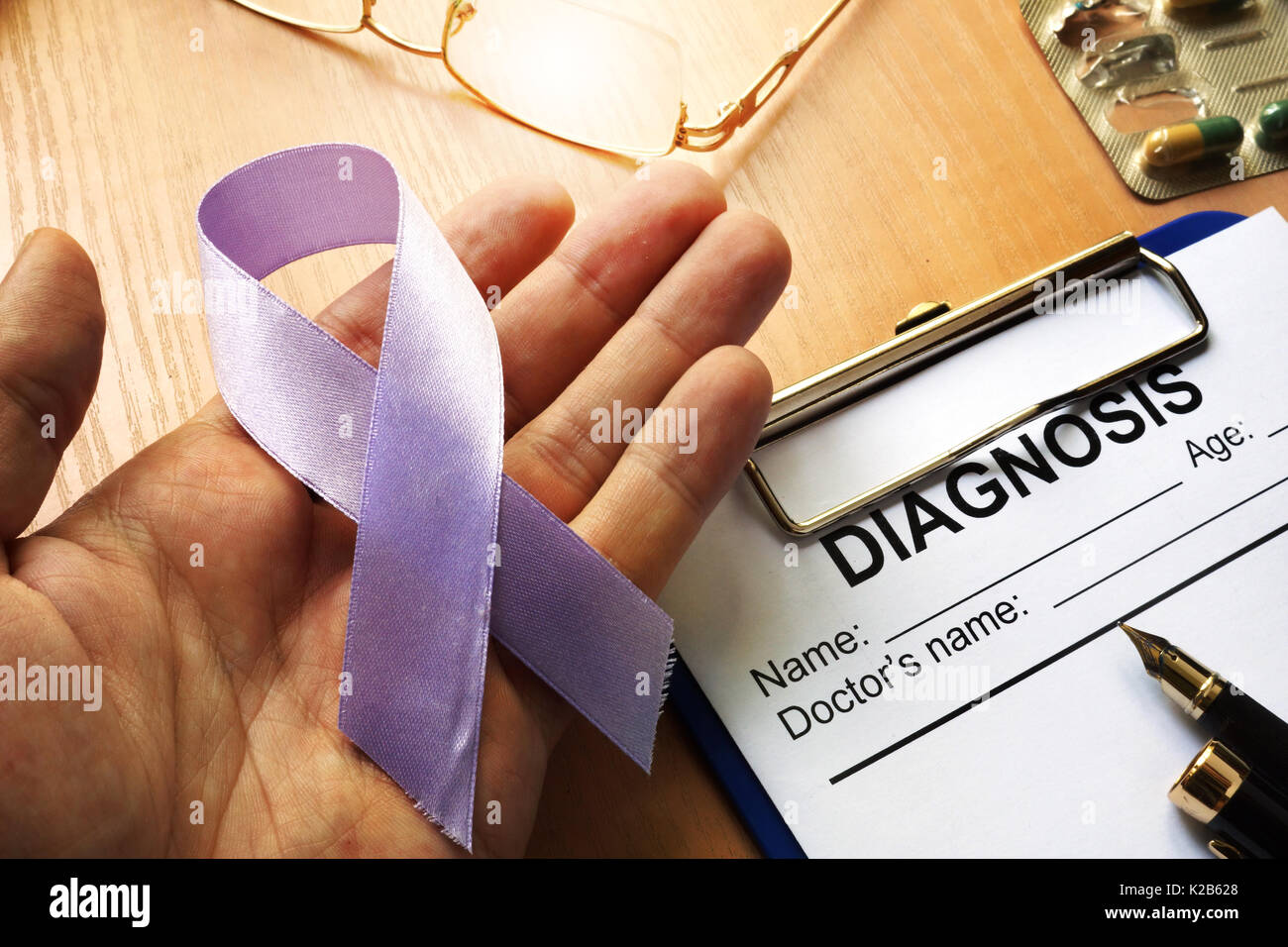 Symbol of cancer. Lavender awareness ribbon Stock Photo - Alamy