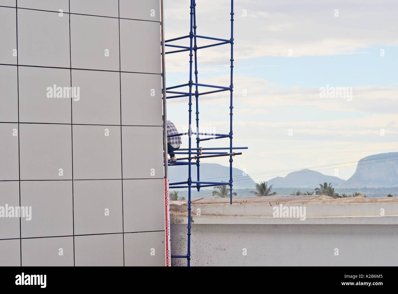 man working on top of a scaffold Stock Photo - Alamy