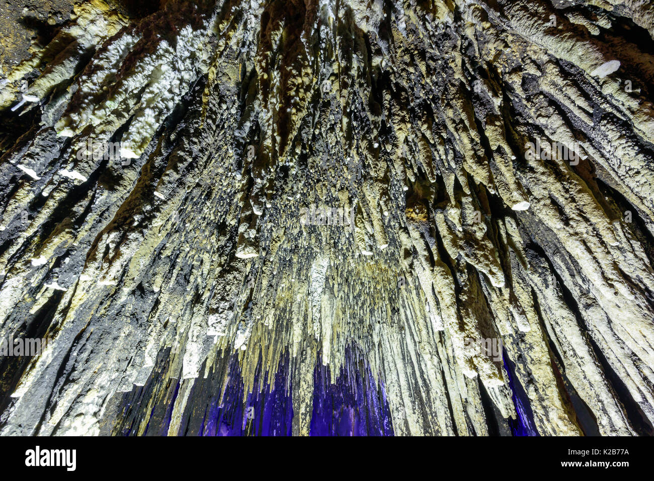 Stalactite stalactites with color lighting in cave Stock Photo - Alamy