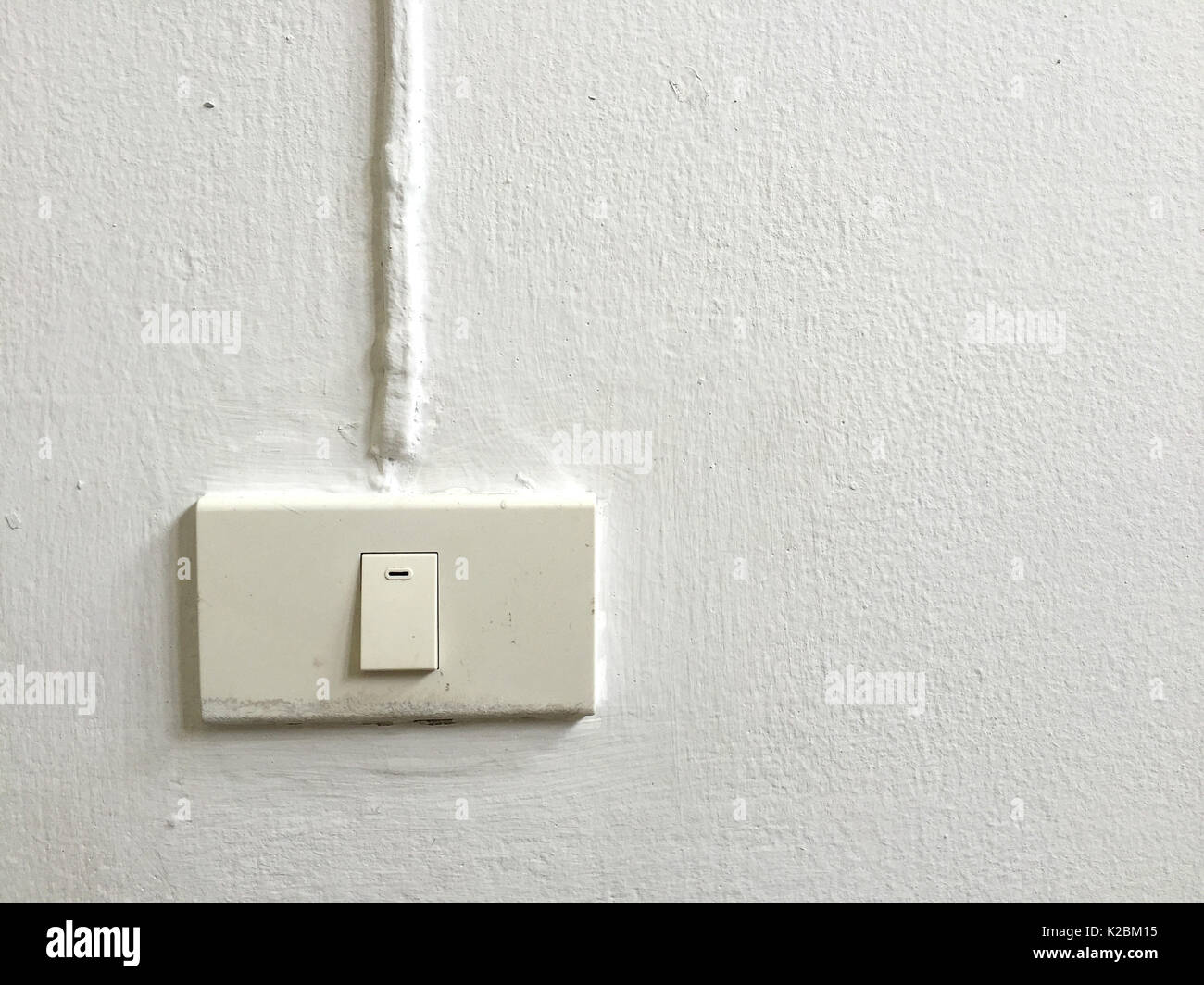 White electric switch on wall Stock Photo - Alamy