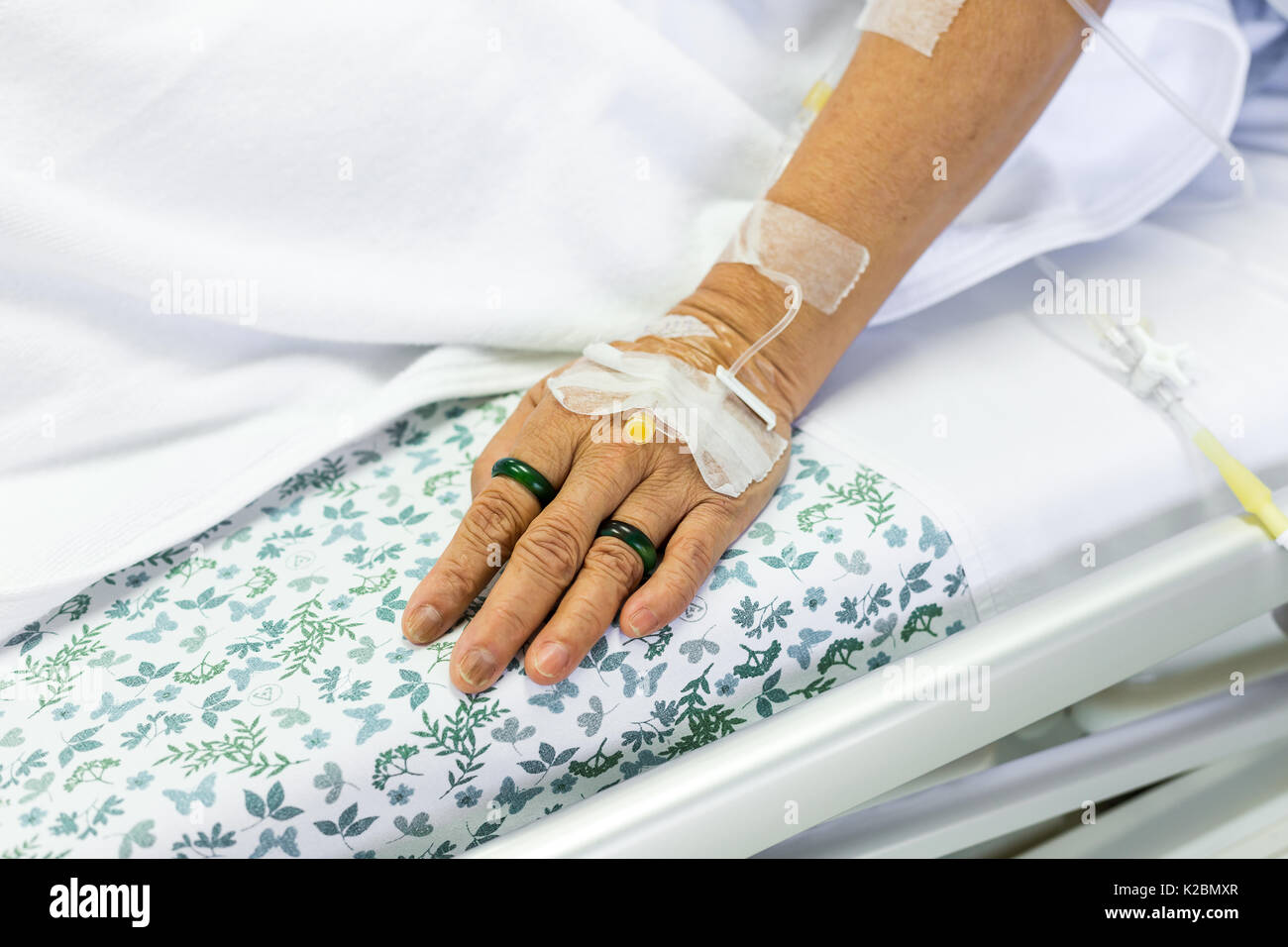Tube of saline solution stick on patient hand to treatment Stock Photo ...