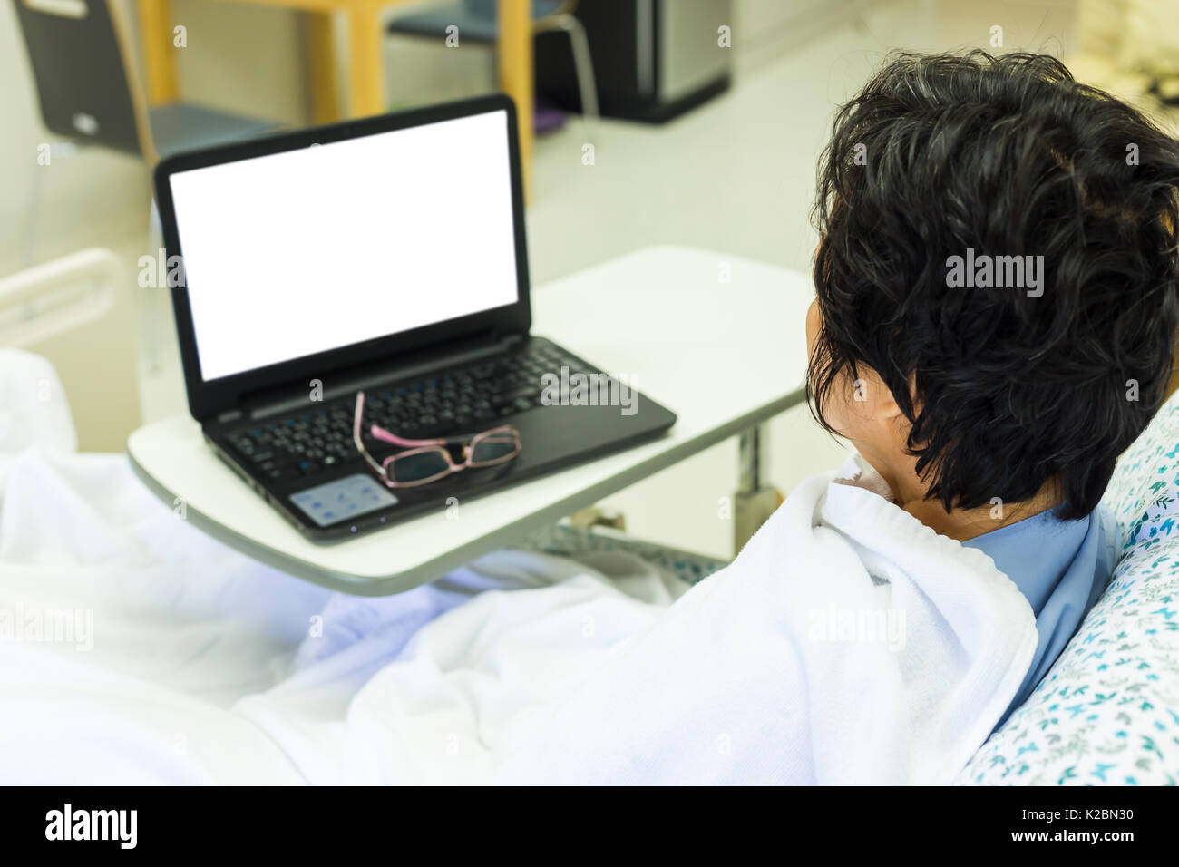 Female patient is watching computer screen for chat with children or ...