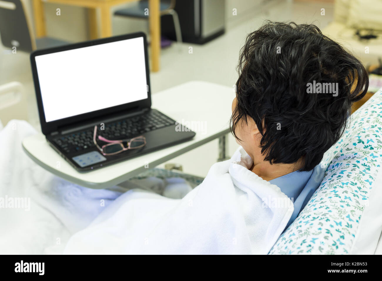 Female patient is watching computer screen for chat with children or ...