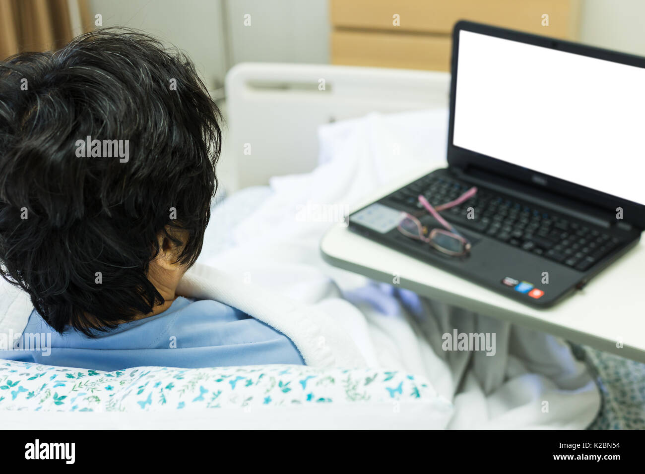 Female patient is watching computer screen for chat with children or ...
